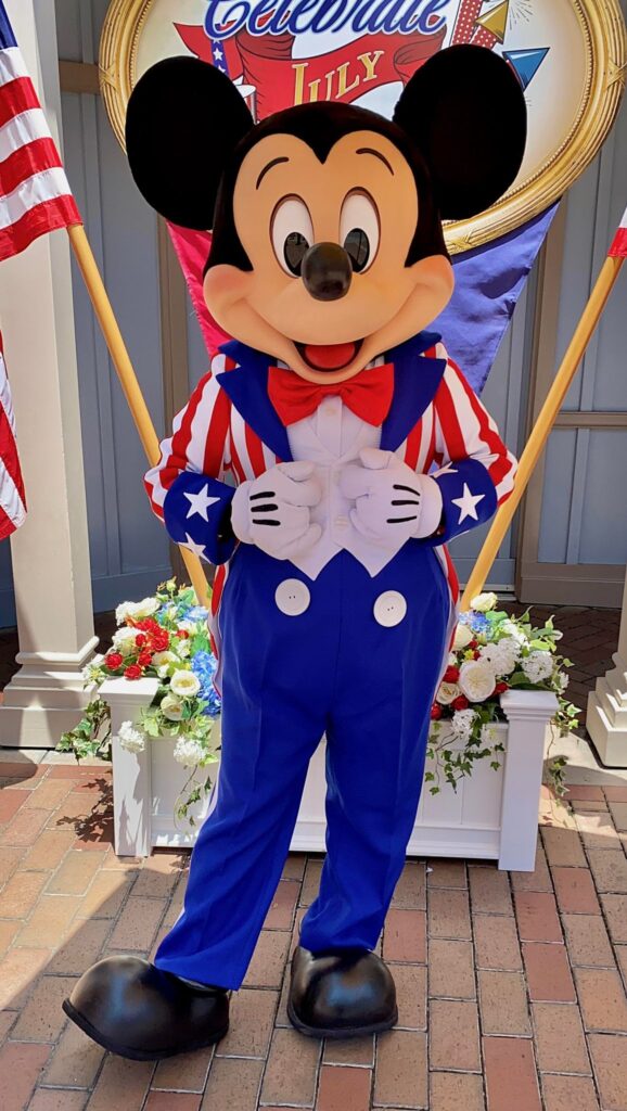 Patriotic Mickey Mouse Greeting Guests in Disneyland | Chip and Company