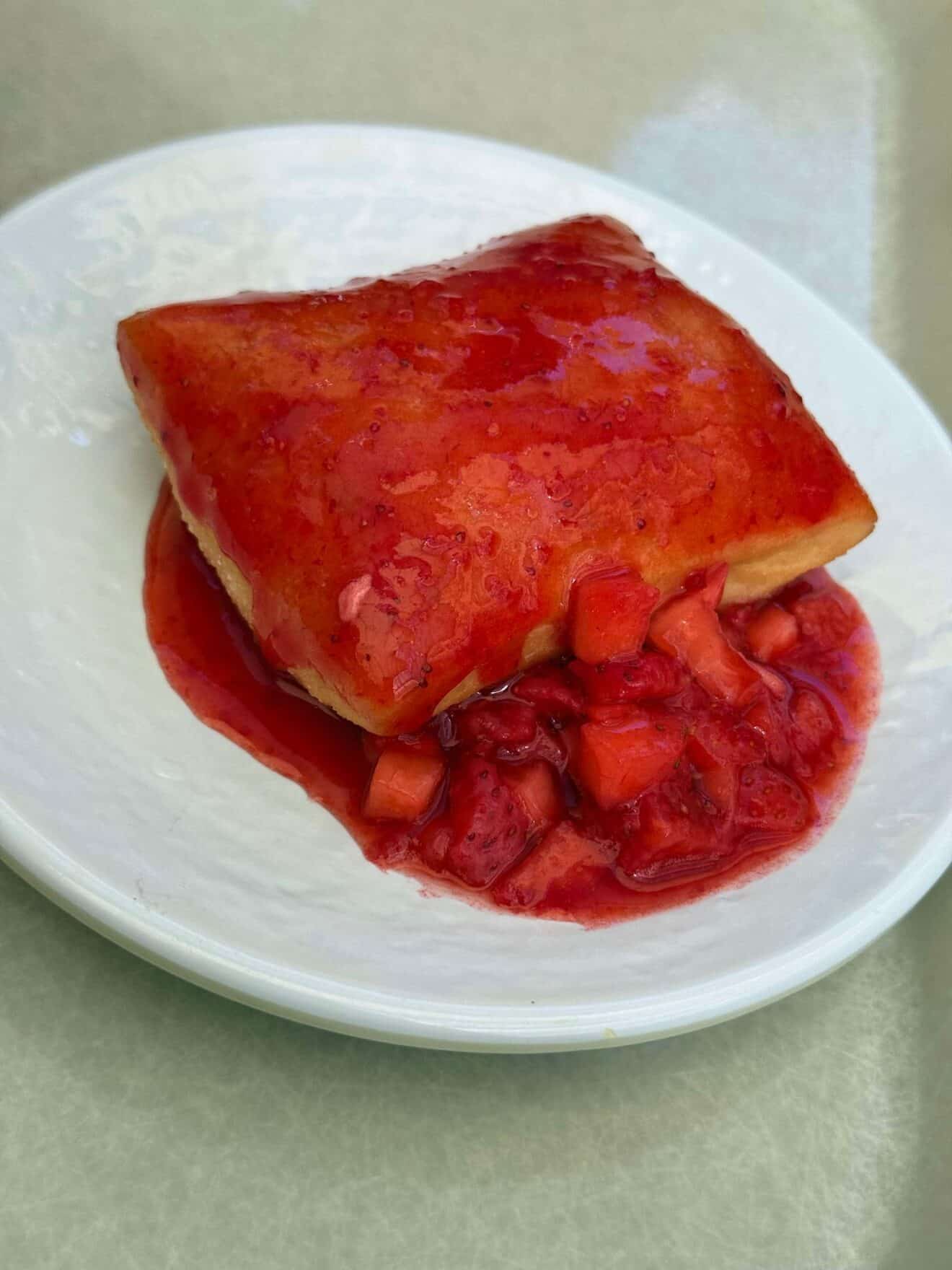 We tried the Strawberry Filled Beignet at Disneyland | Chip and Company